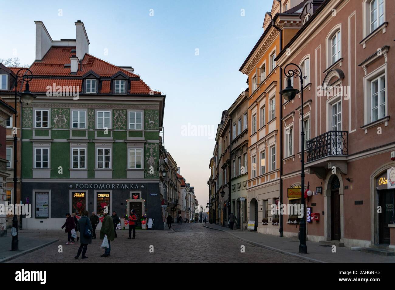 City street of old town in Warsaw. Narrow street between colorful ...