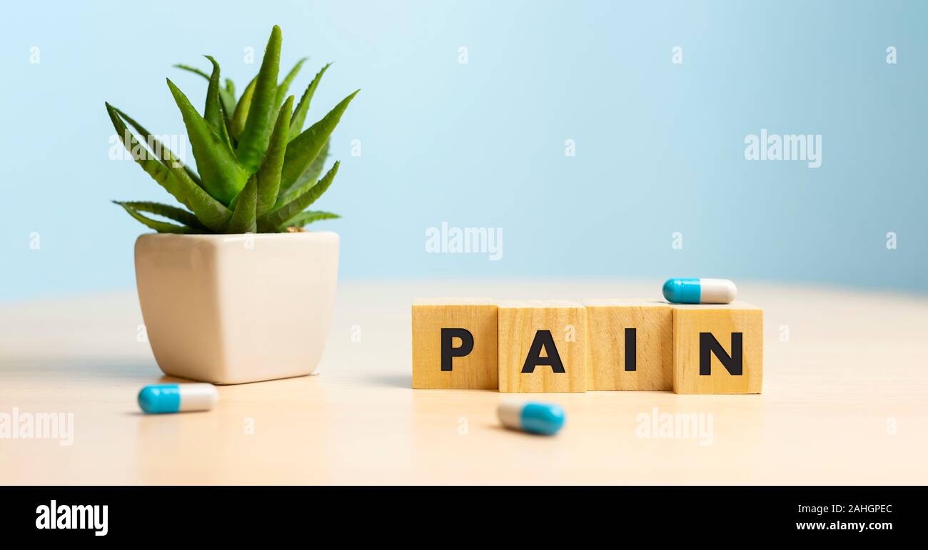 Pain word concept on wood cube, Medical concept Stock Photo - Alamy
