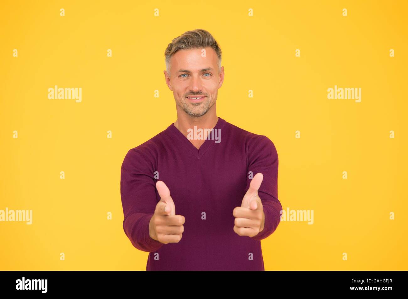 Only you. Handsome guy pointing yellow background. Happy man pointing ...