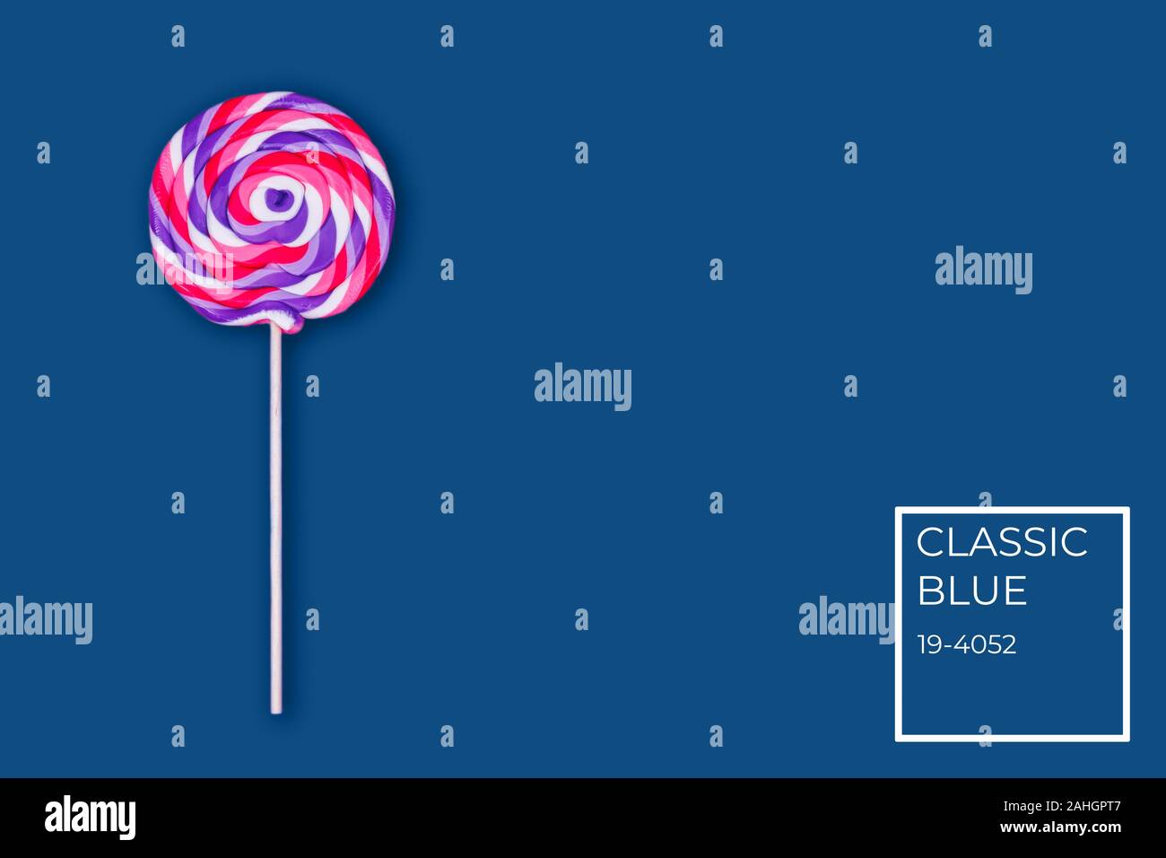 Big lollipop on solid classic blue background. Horizontal with color ...