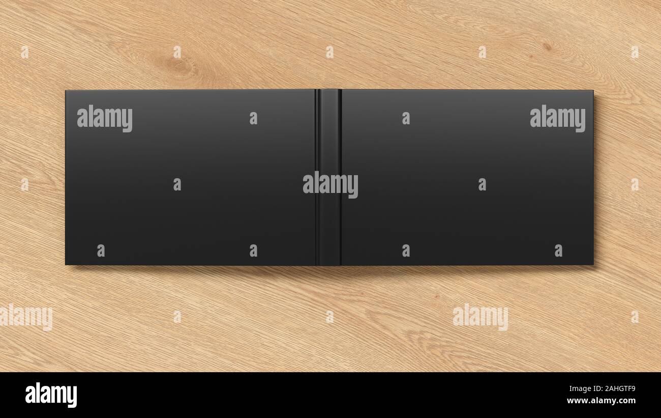 Blank black horizontal open and upside down book cover on wooden ...