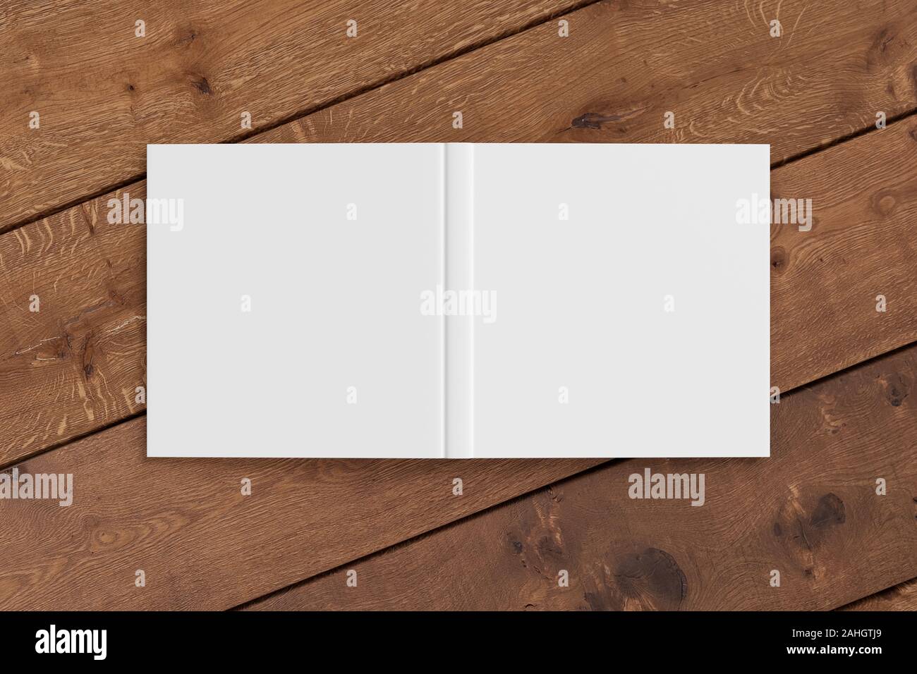 Blank white square open and upside down book cover on wooden boards ...