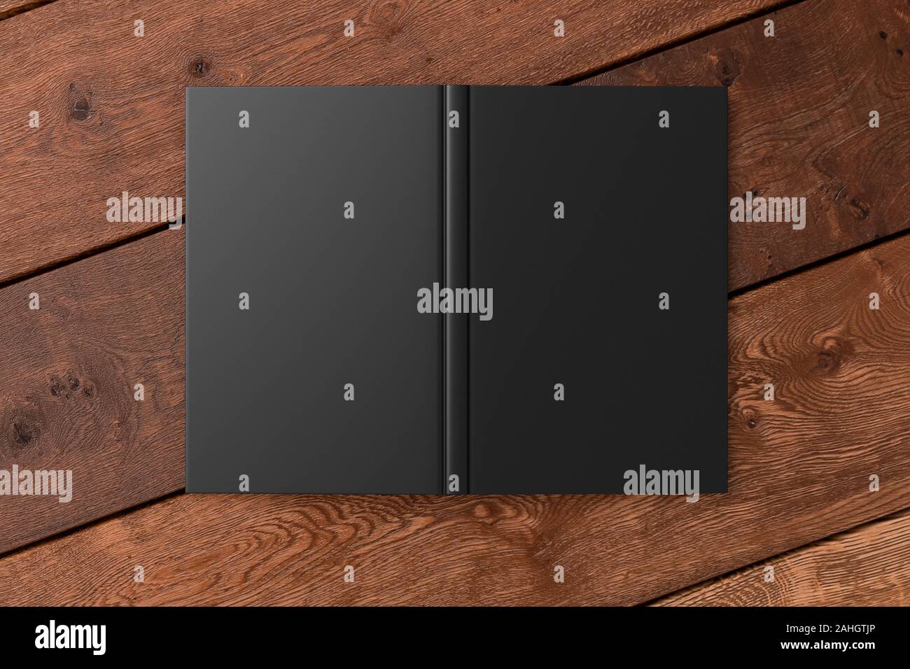 Blank black vertical open and upside down book cover on wooden boards ...