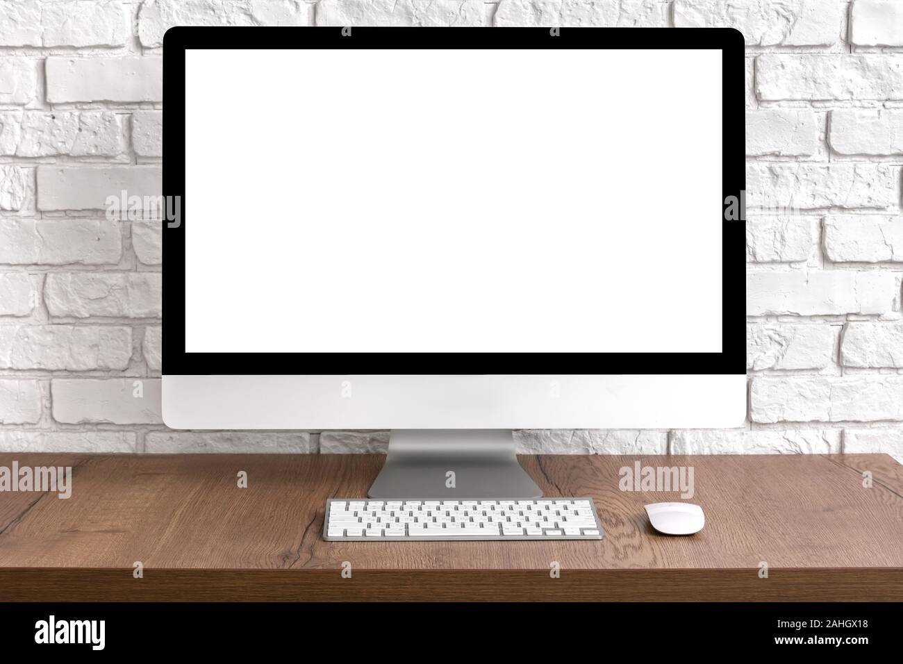 Mock up blank screen computer desktop with keyboard and mouse on wooden ...