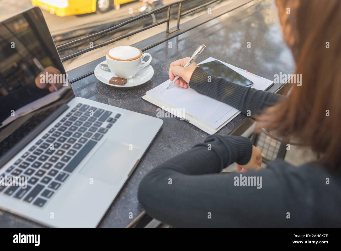 Young Asian girl writing notes Stock Photo - Alamy