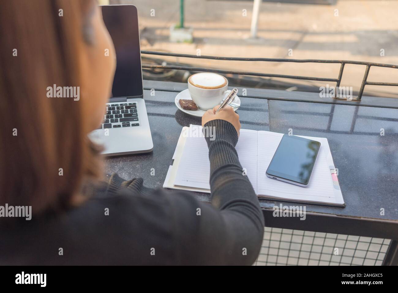 Asian woman writing notes hi-res stock photography and images - Alamy