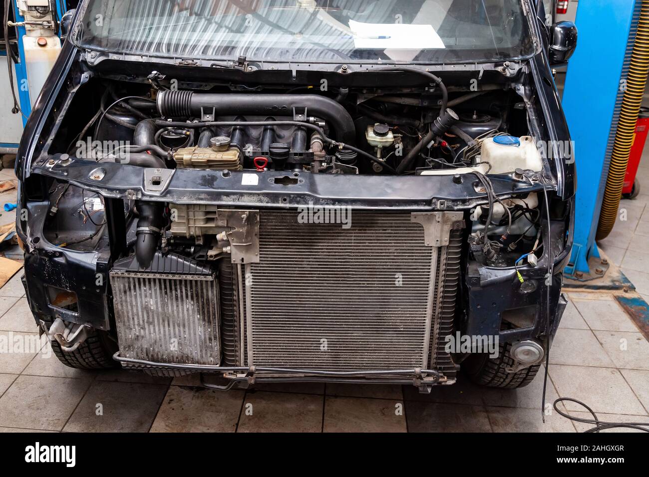 Disassembled black car in the workshop prepared for repair: front end ...