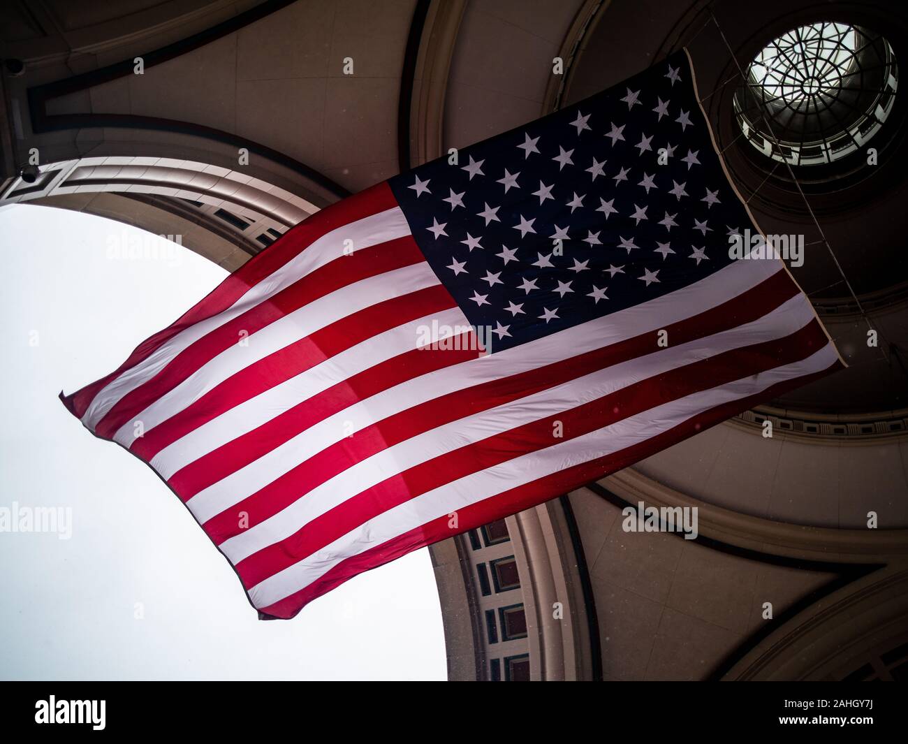 The American Flag Flies High Beneath An Arch Stock Photo - Alamy
