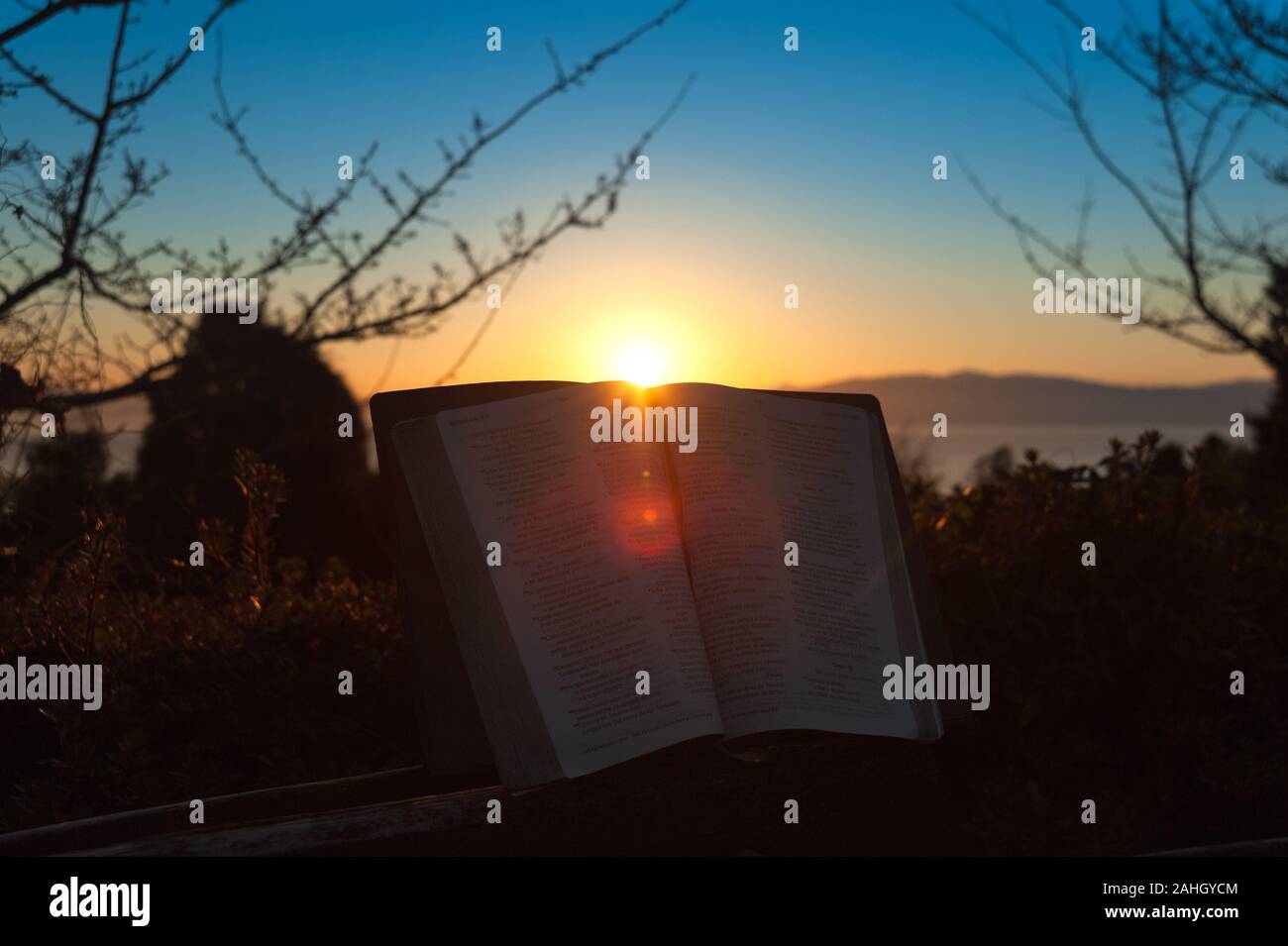 Open bible at sunrise with flare in Fuji city, Japan. Background with ...