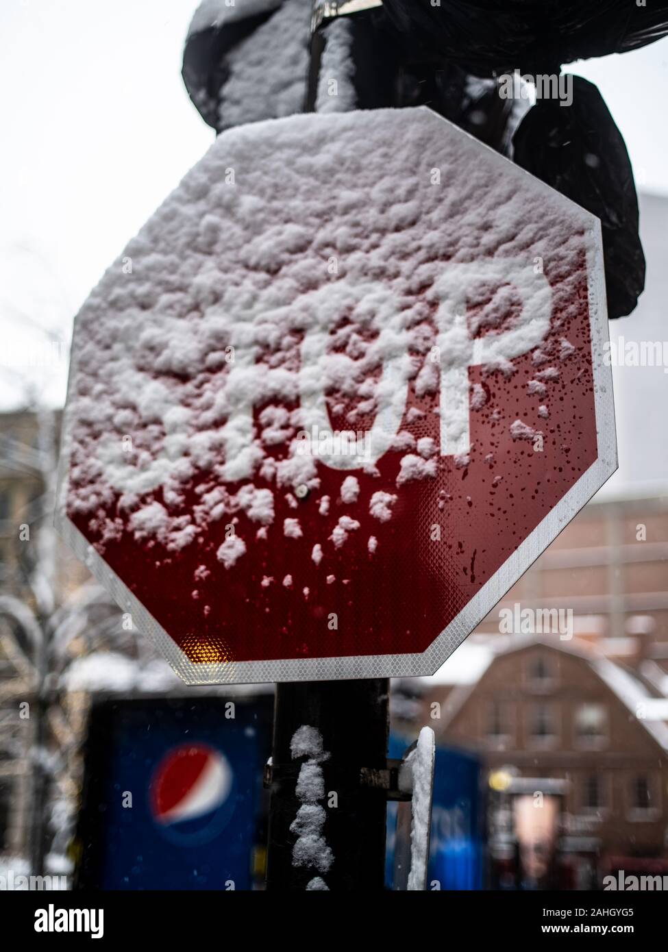 Snow covered red and white stop sign hi-res stock photography and ...
