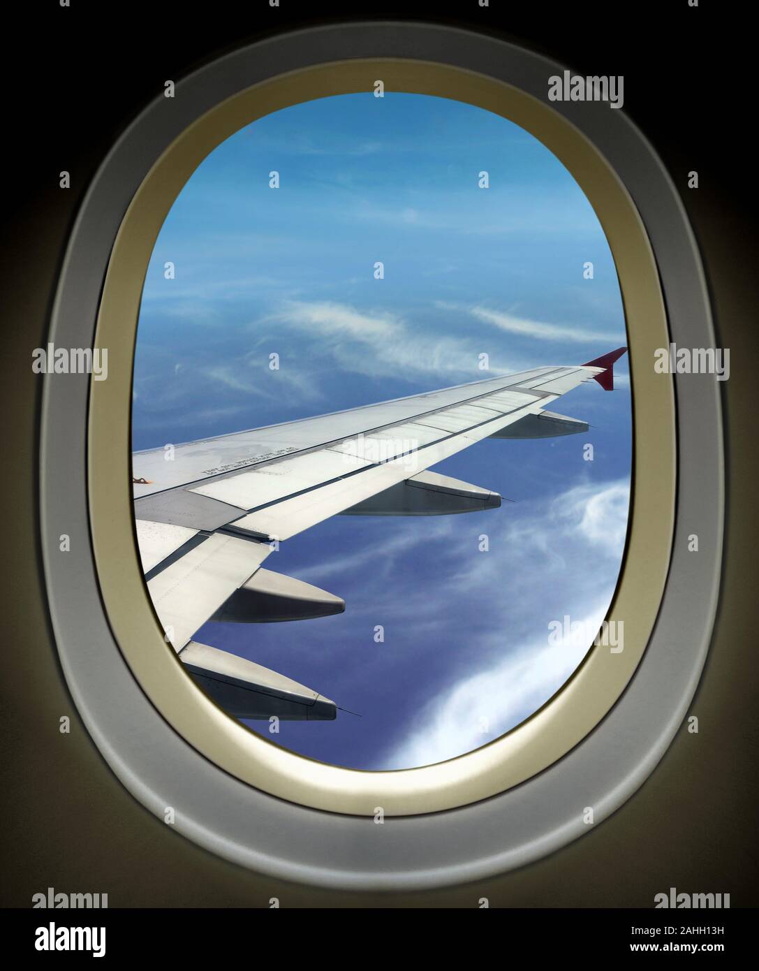 airplane window wing view and bright cloudy blue sky Stock Photo - Alamy