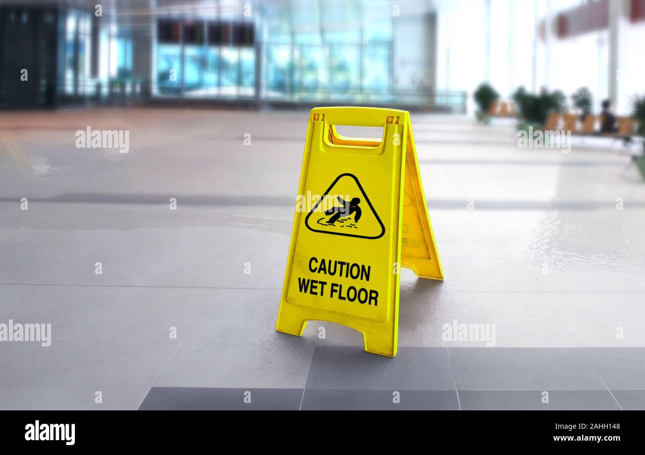 Caution wet slippery floor sign in the building Stock Photo - Alamy