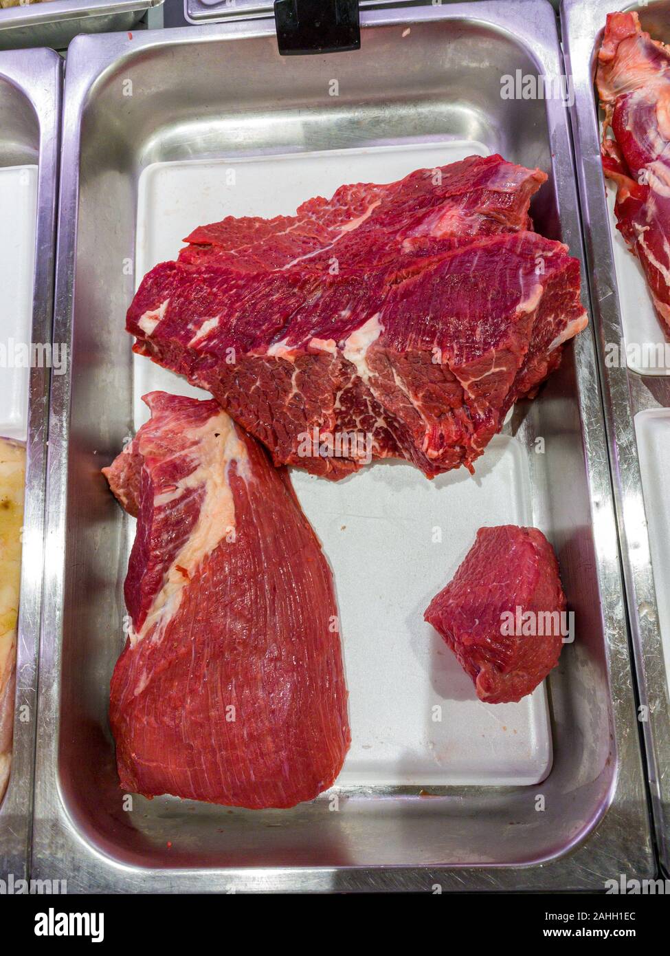 Vertical photo of fresh beef meat at butcher shop Stock Photo - Alamy