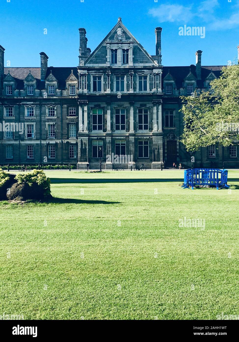 Old Building in Trinity College surrounded by the green grass of the ...