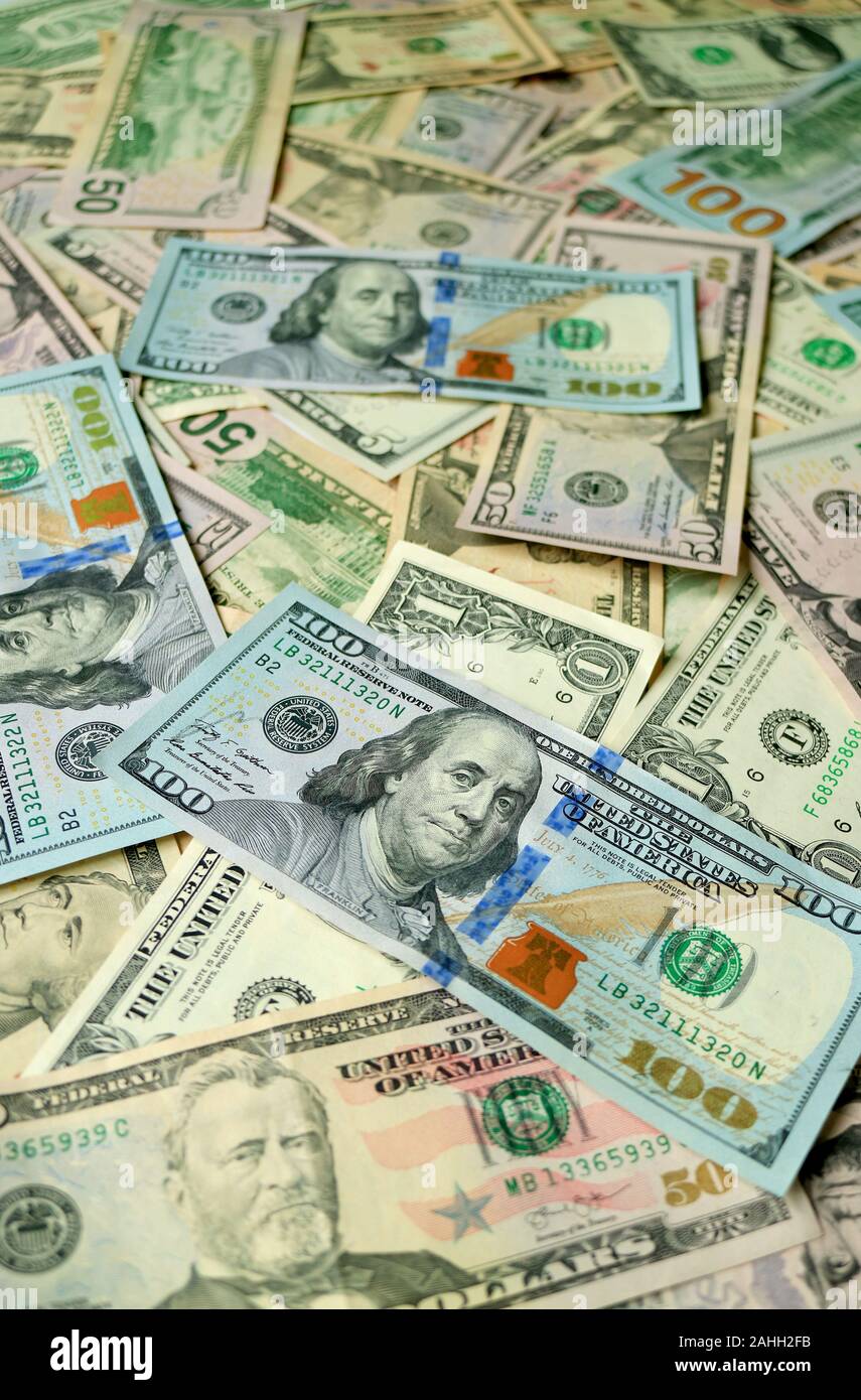 Vertical image of uncountable United States dollar banknotes with ...