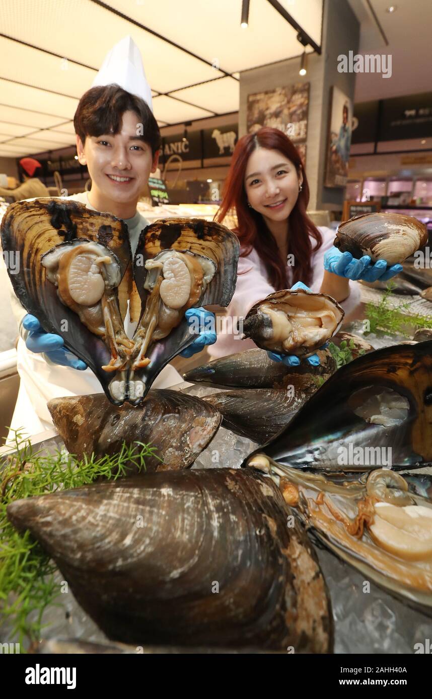 Seoul, South Korea. 30th Dec, 2019. Giant clams on sale Models show off ...