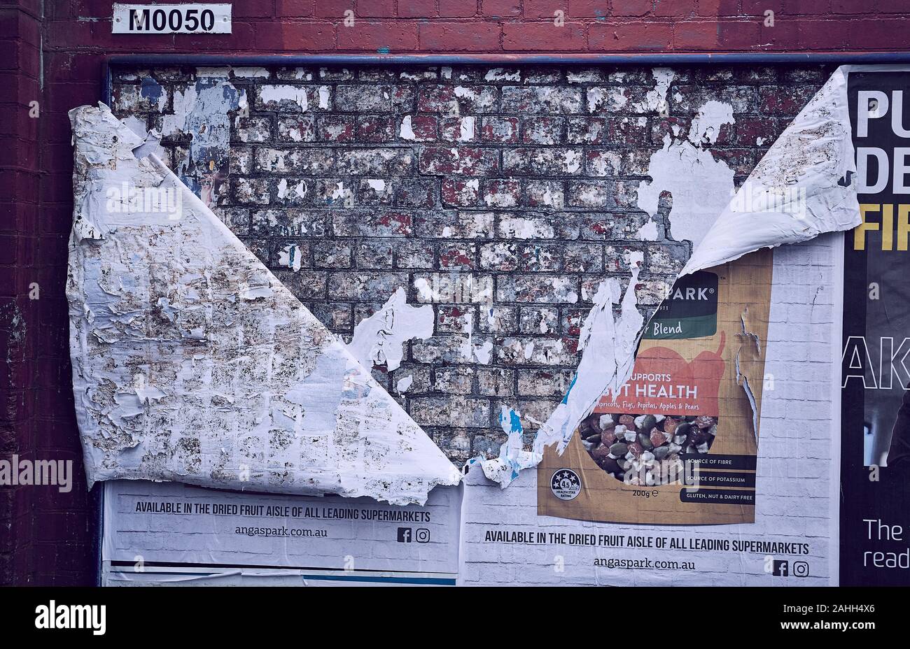 Peeling posters in a brick wall under a railway bridge in Melbourne ...