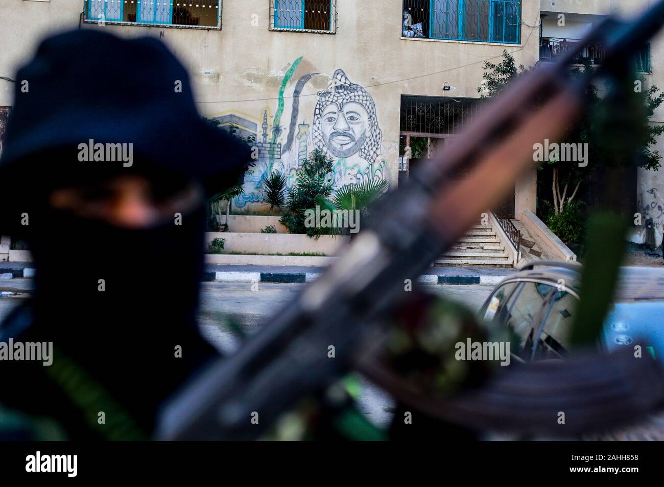 Graffiti of Palestinian leader, Yassar Arafat on a building wall during ...