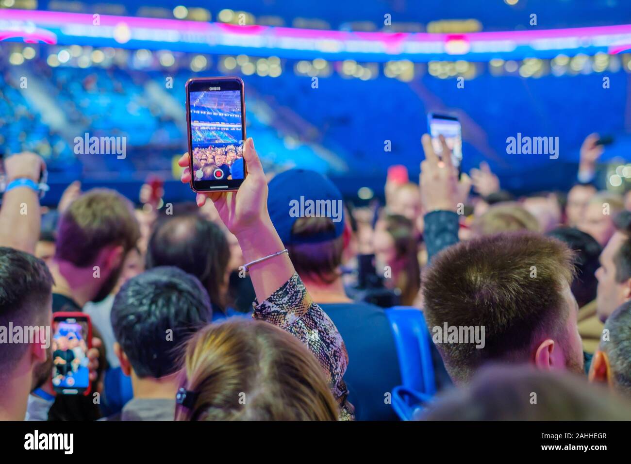 Audience at event uses smartphone camera to take photos and videos ...