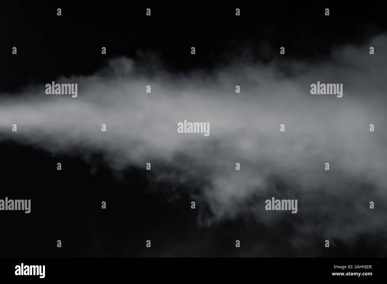 Smoke spray spit from left side on black background Stock Photo - Alamy