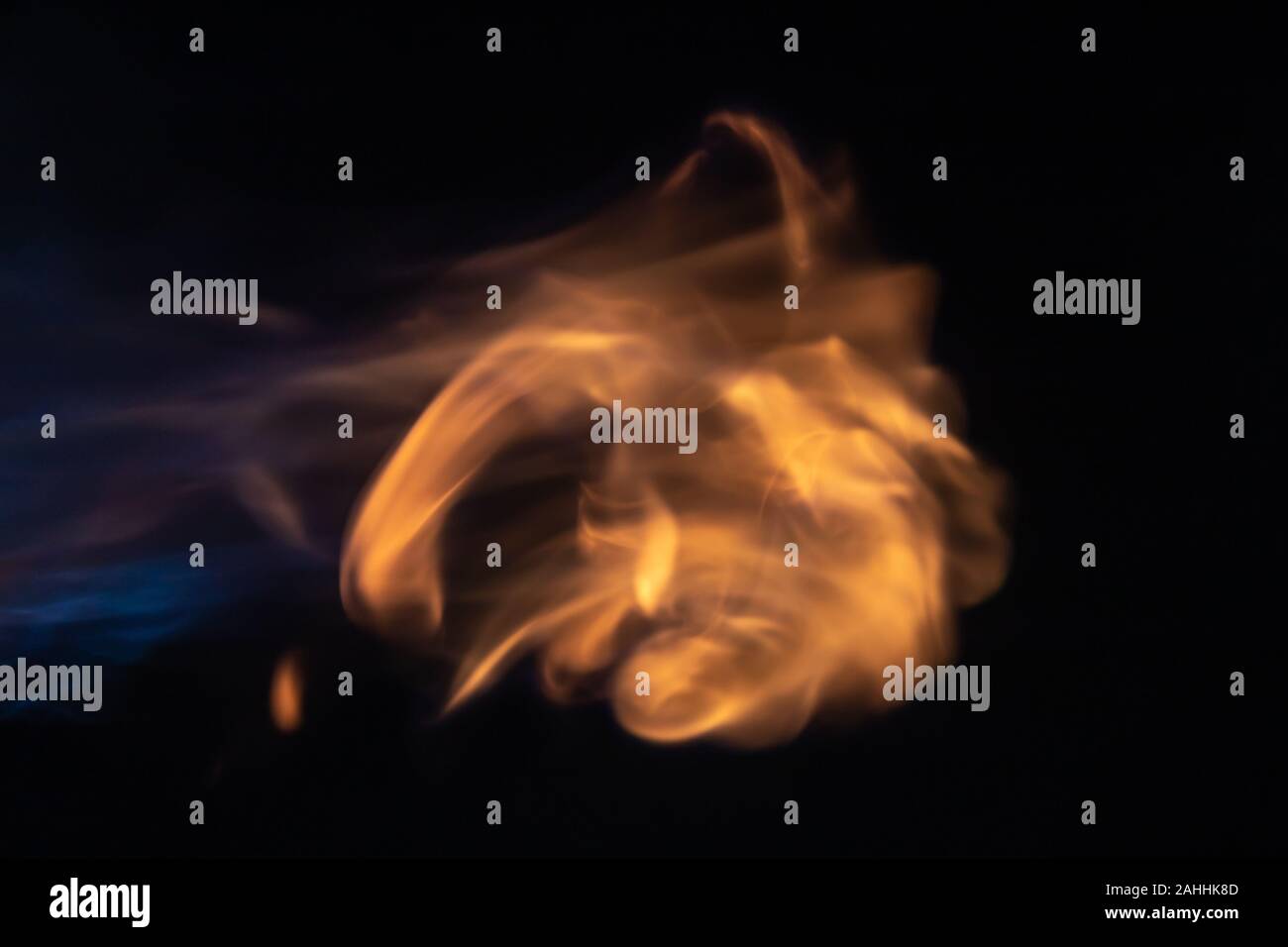 Throw soft blur flame with blue flame from the left side on black ...