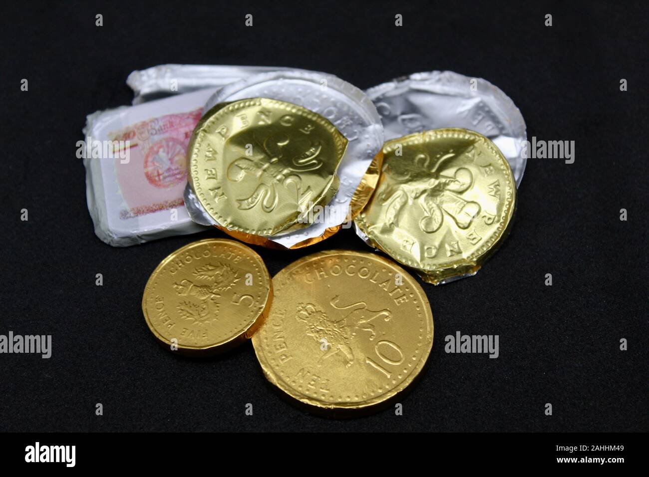 Gold coloured chocolate coin foil wrappings Stock Photo - Alamy