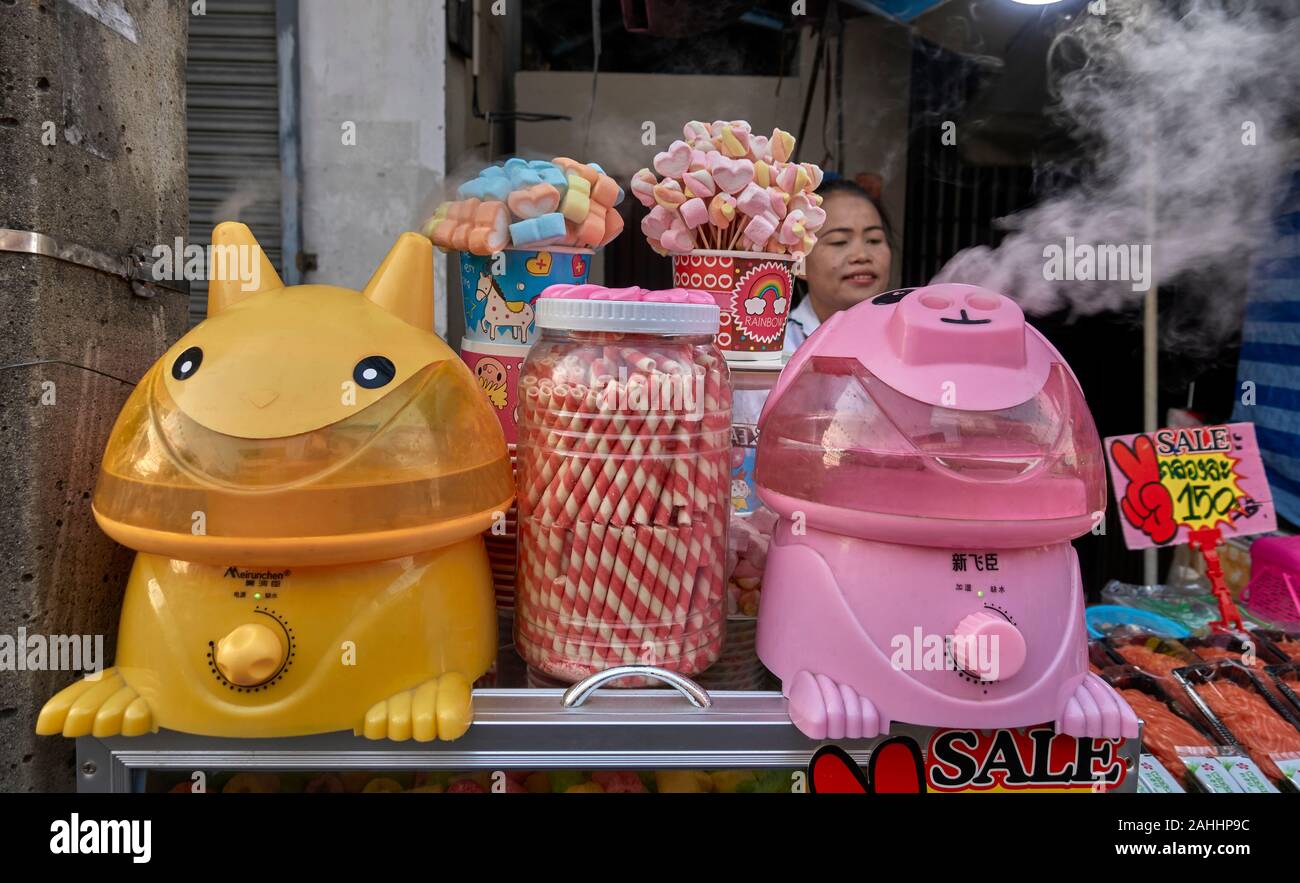 Candy and hot marshmallow stall with steaming pots for heating the ...