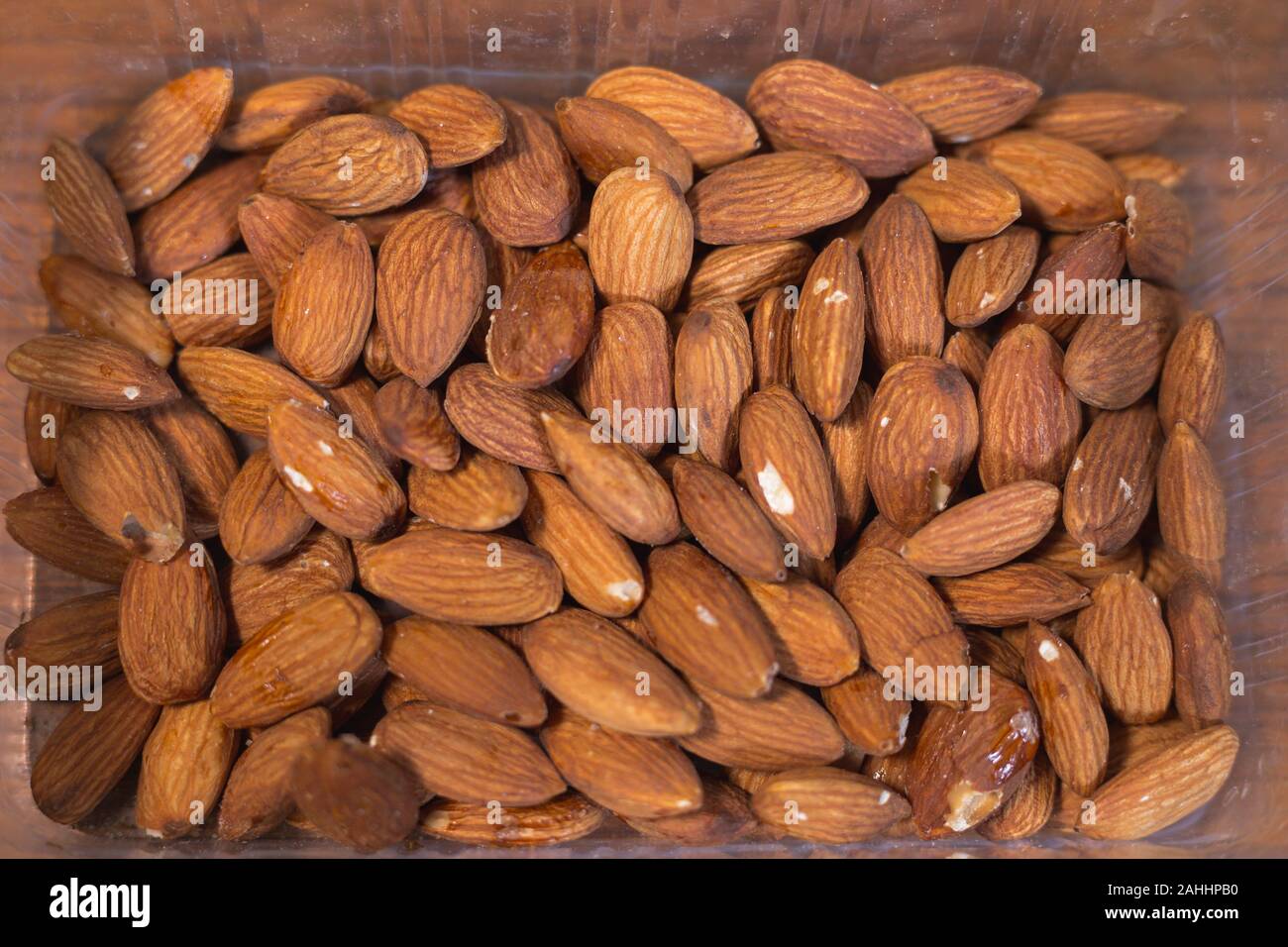 Pile of almonds in the plastic box Stock Photo - Alamy