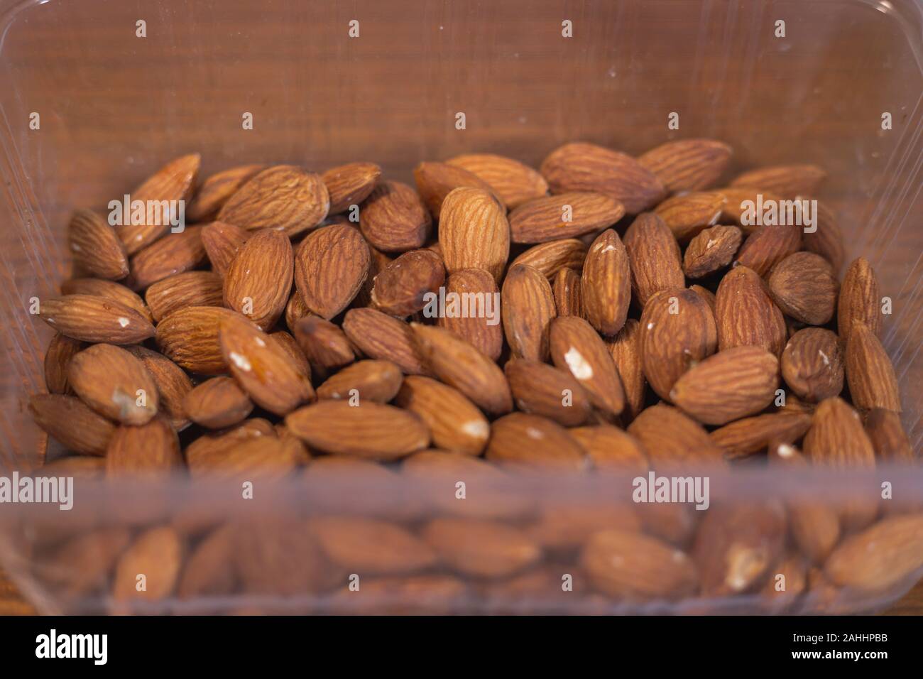 Pile of almonds in the plastic box Stock Photo - Alamy
