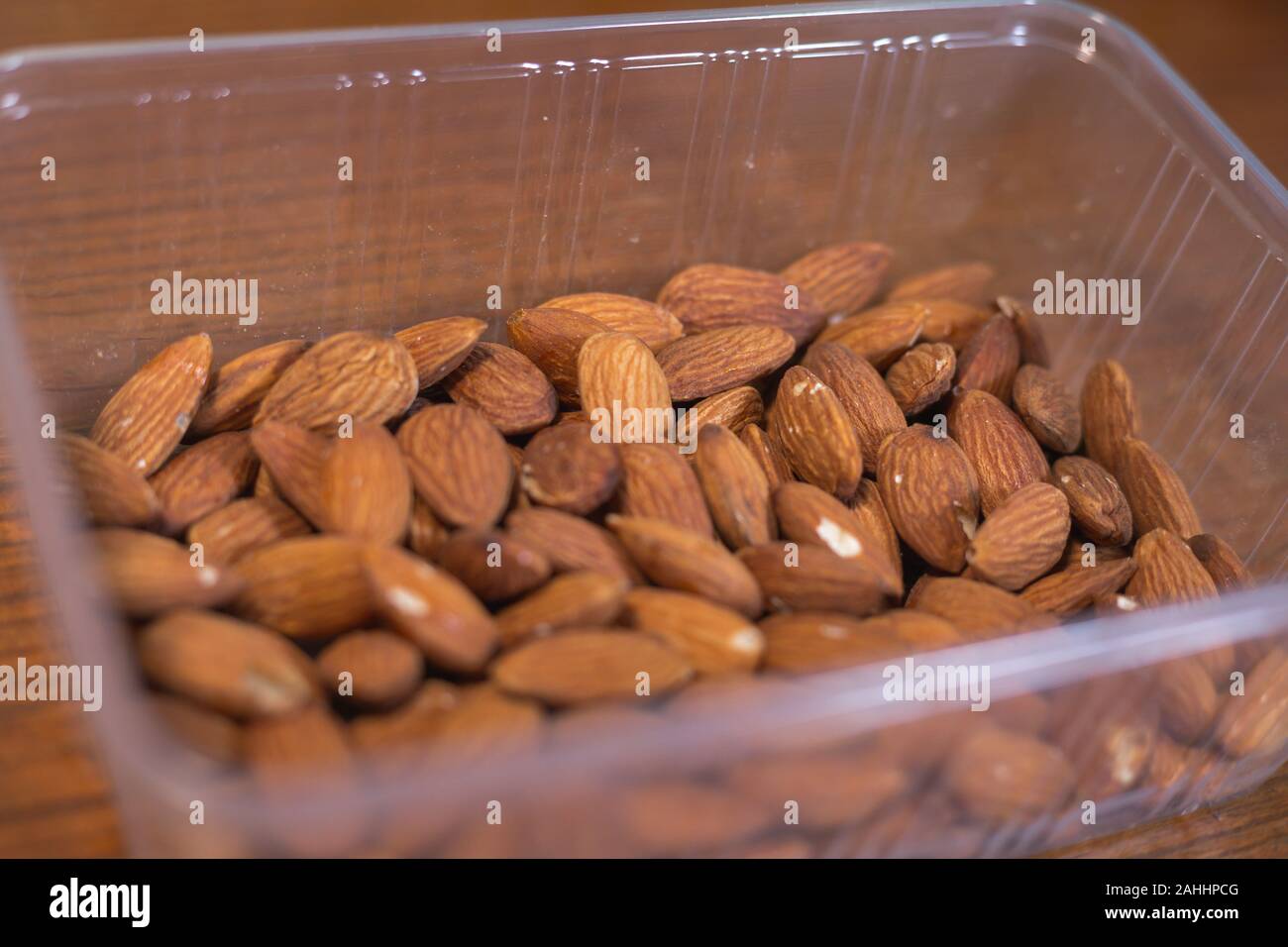 Pile of almonds in the plastic box Stock Photo - Alamy