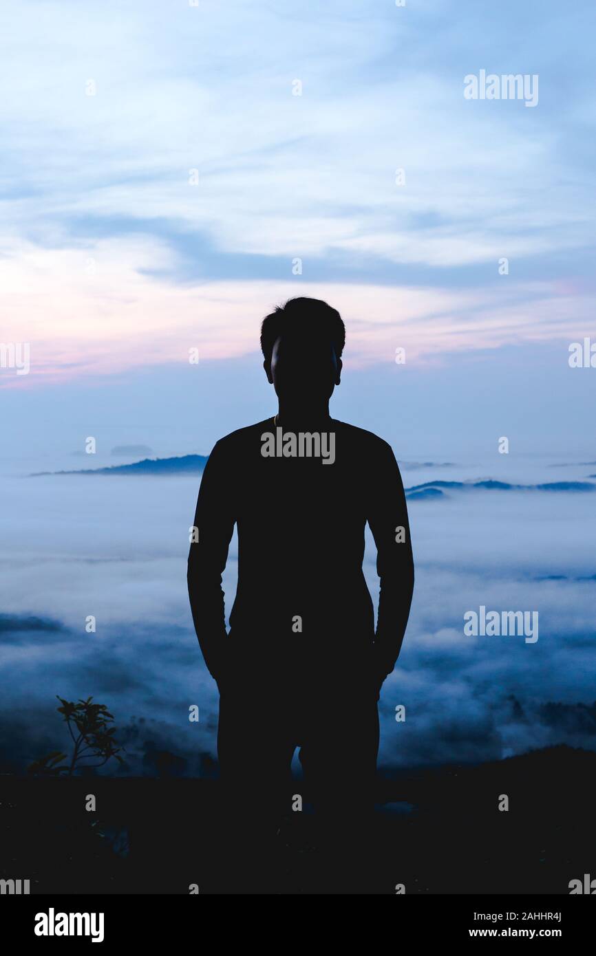 Silhouette man put his hands in trouser stand forward Hill view of ...