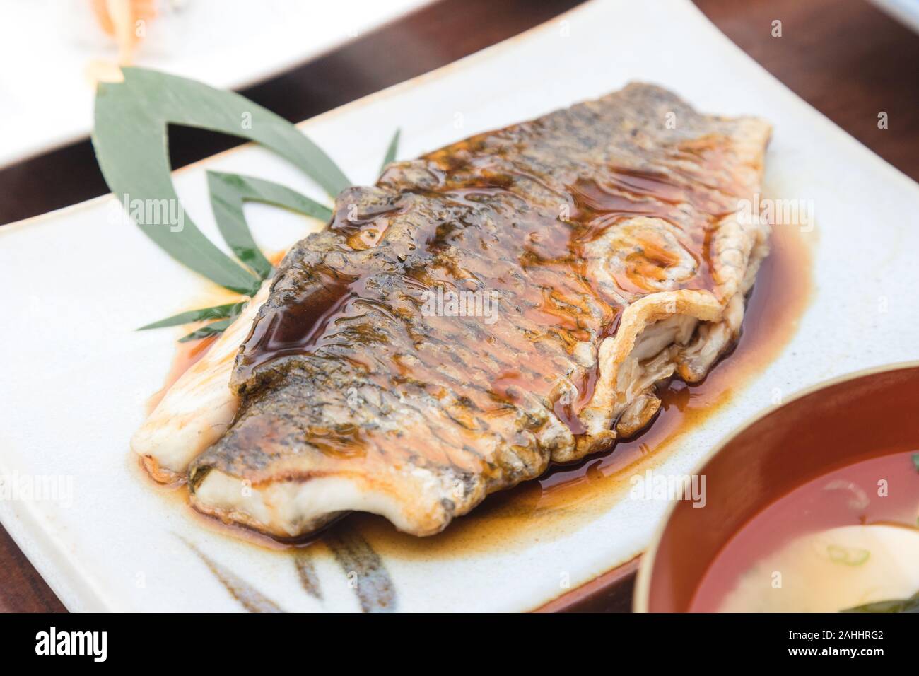 fish slice fried with teriyaki sauce serve on japanese plate Stock ...