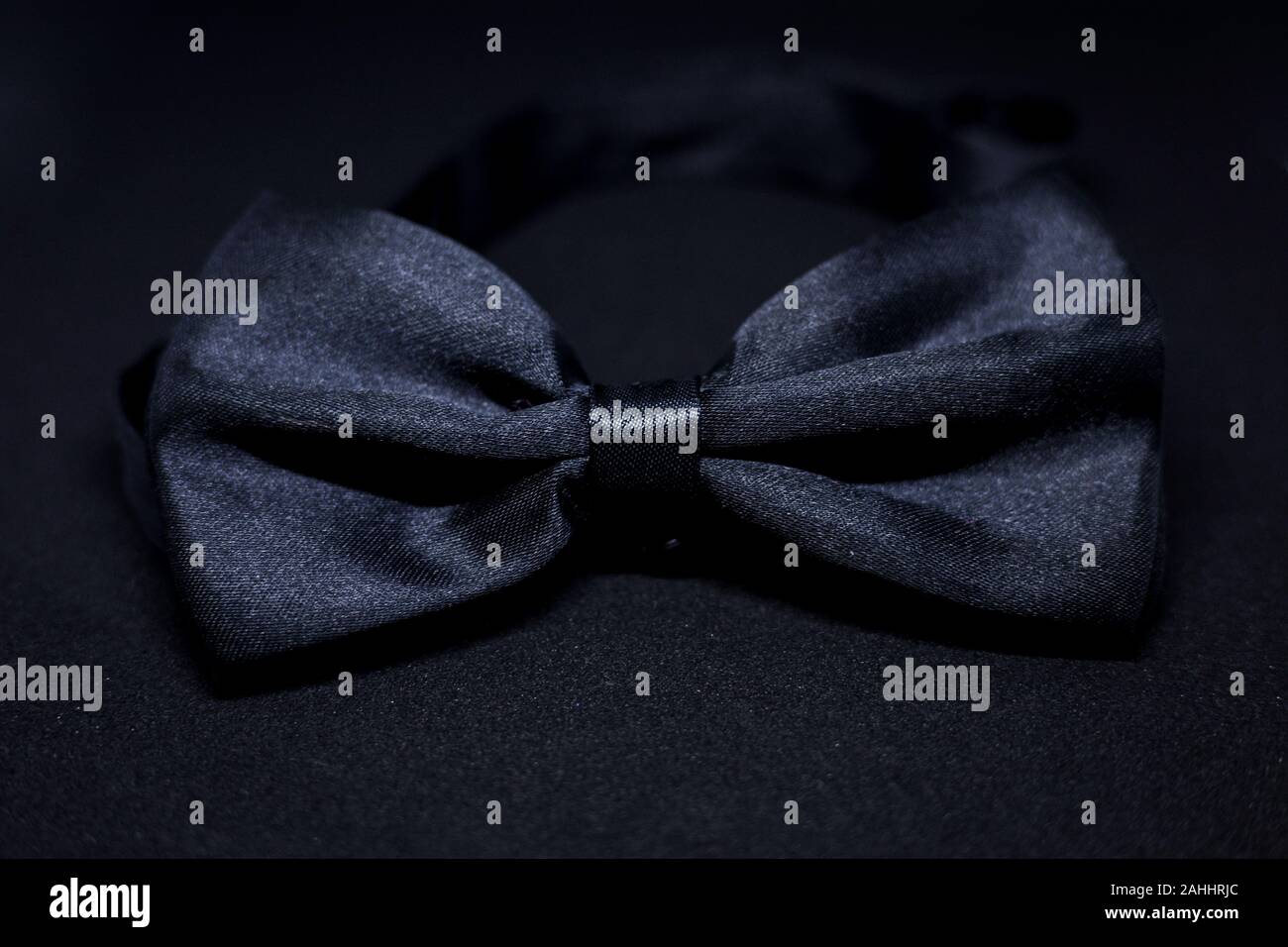 black ribbon for suit cloth on luxury black bg Stock Photo - Alamy