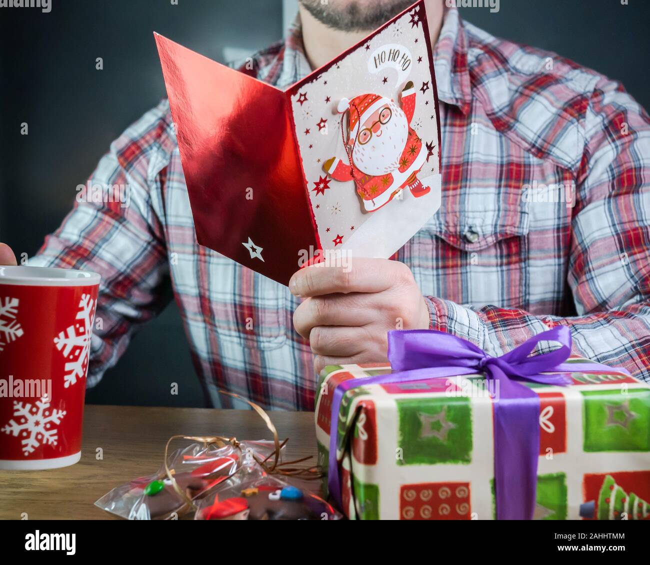 Man reading a Christmas card Stock Photo - Alamy