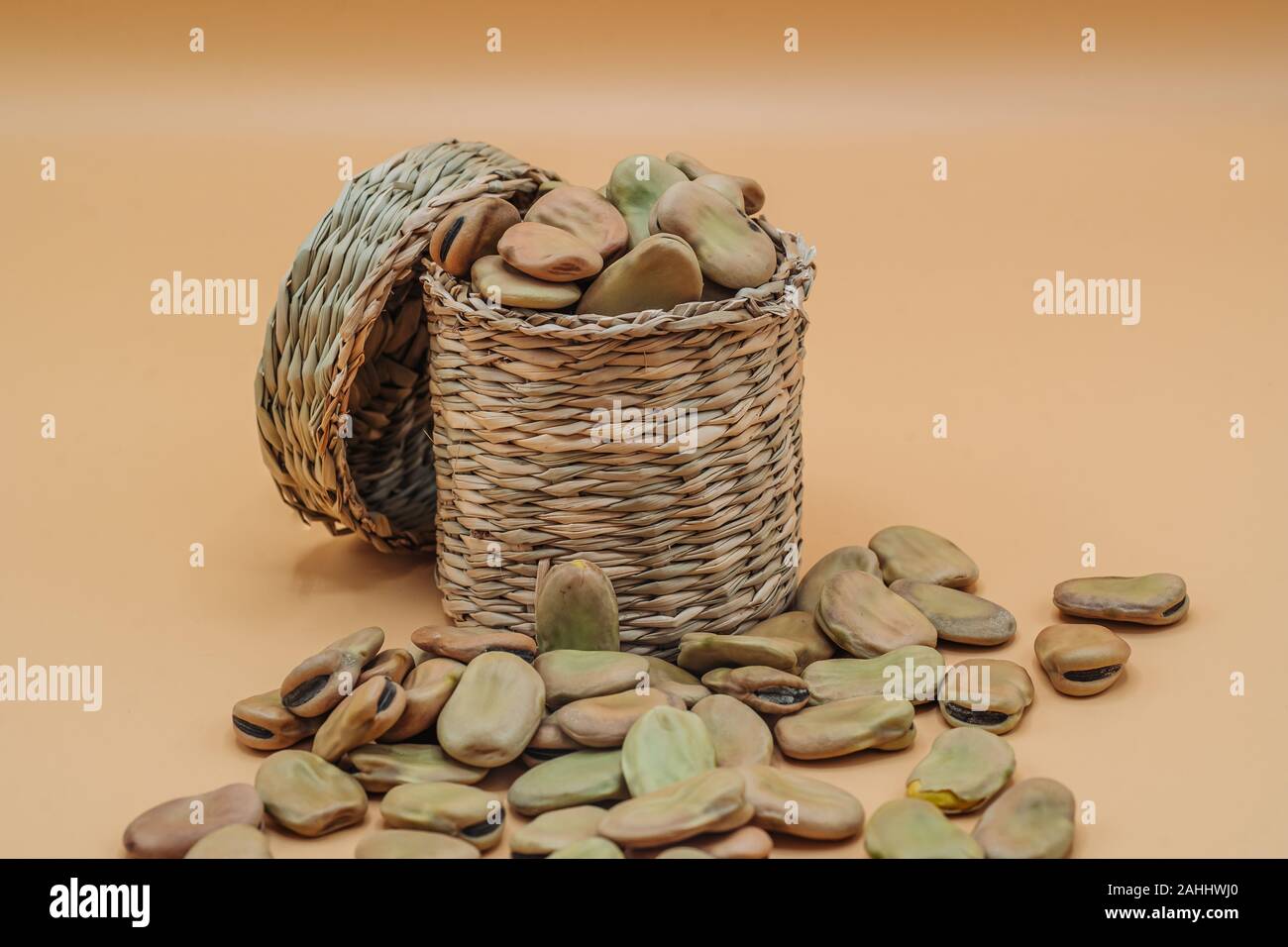 Healthy organic dried broad beans in a straw basket Stock Photo - Alamy