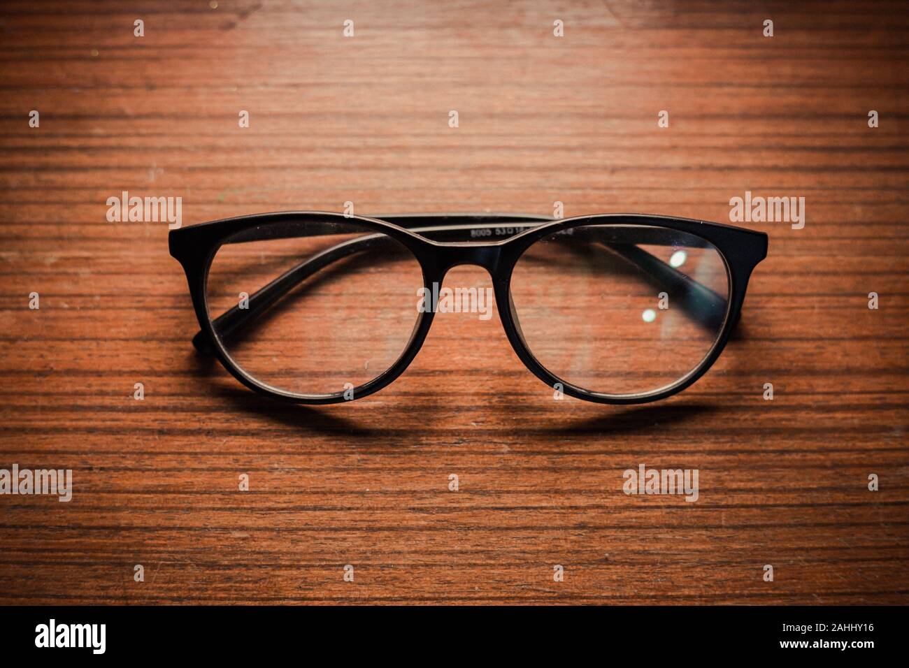 luxury eye glasses on wood table Stock Photo - Alamy