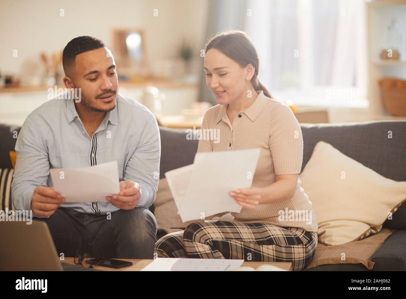 Young couple looking at paperwork hi-res stock photography and images ...