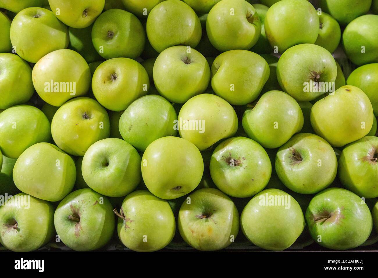 Green apple pile put together looking from the top view at market Stock ...