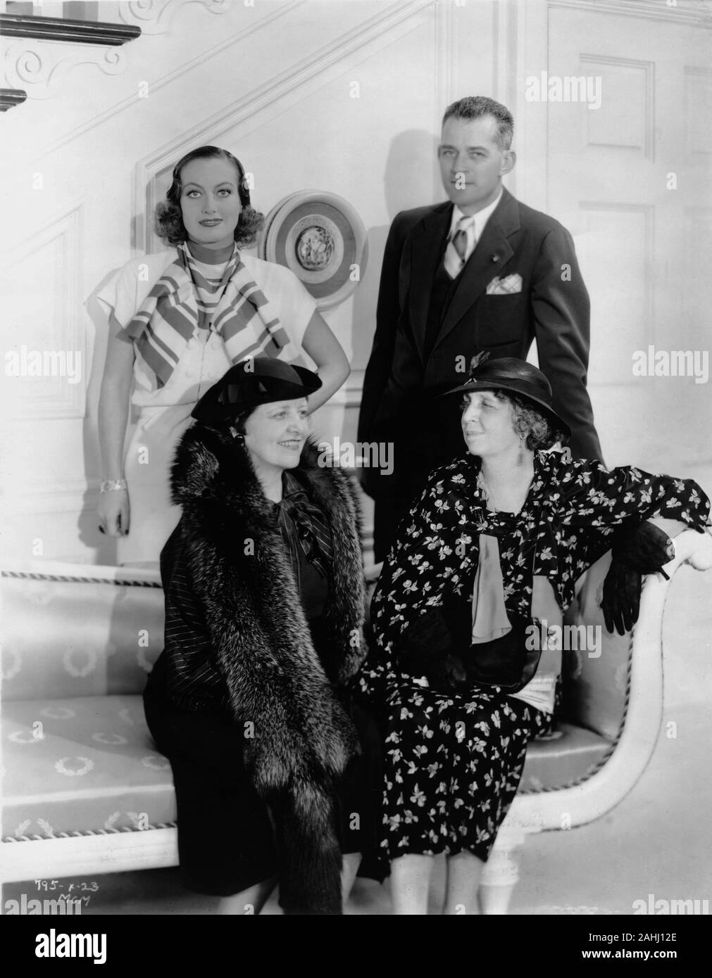 JOAN CRAWFORD wearing gown by Gilbert Adrian and Director W. S. VAN ...