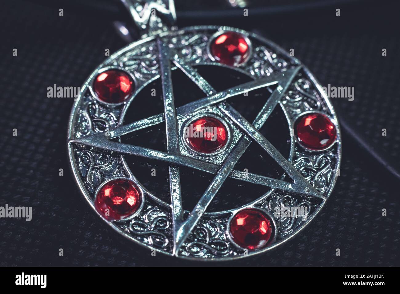 Witch amulet, have 5 pointed star and red jewelry on it Stock Photo - Alamy