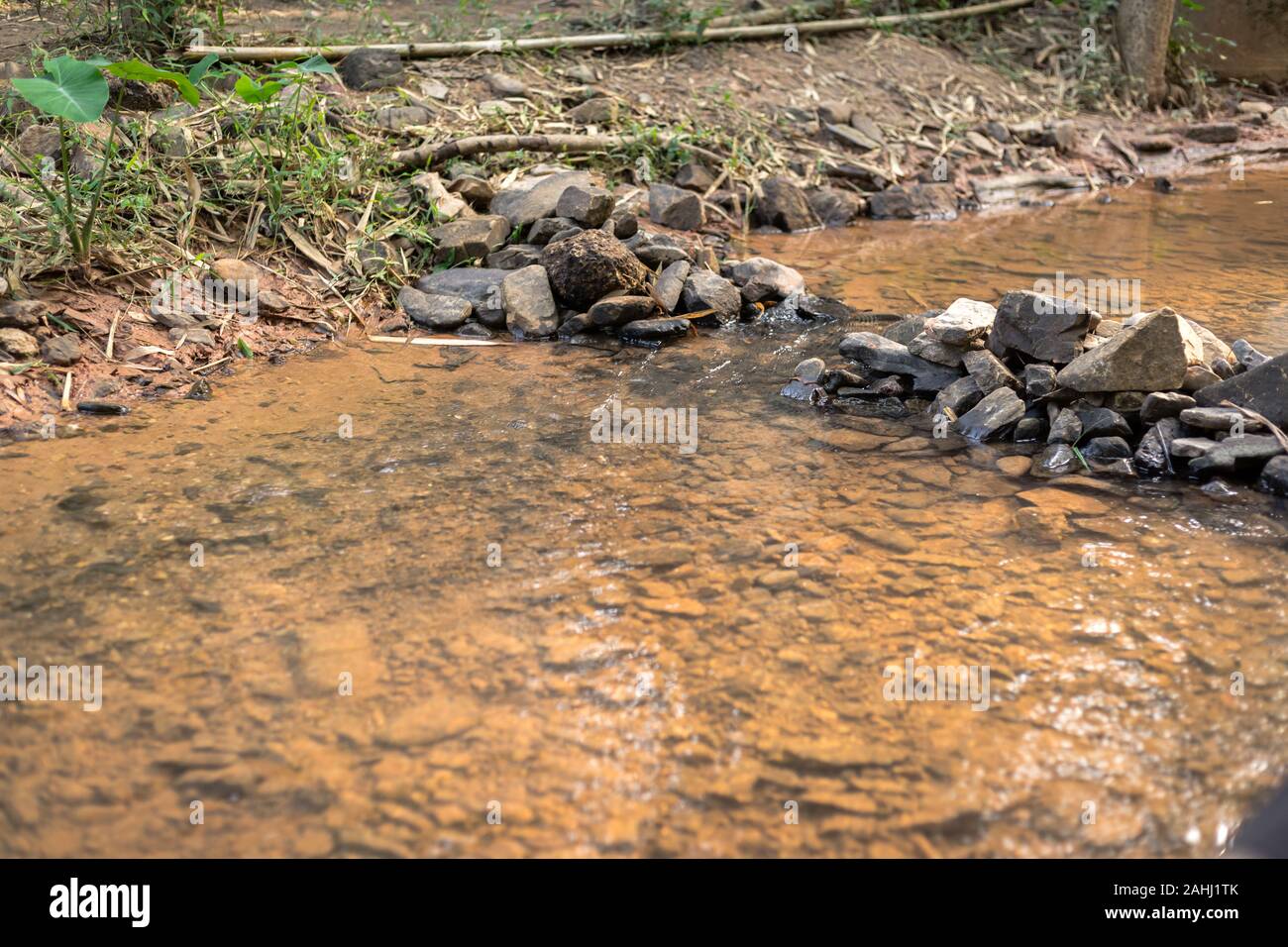 weir in river made from natural stone Stock Photo - Alamy