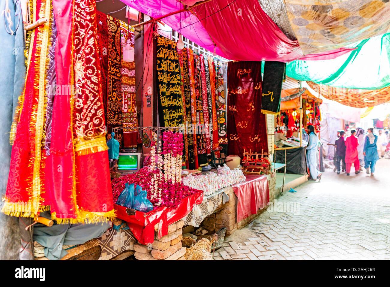 Sehwan Sharif Common Street Picturesque View of a Bazaar Shop Selling Flowers and Islamic ...