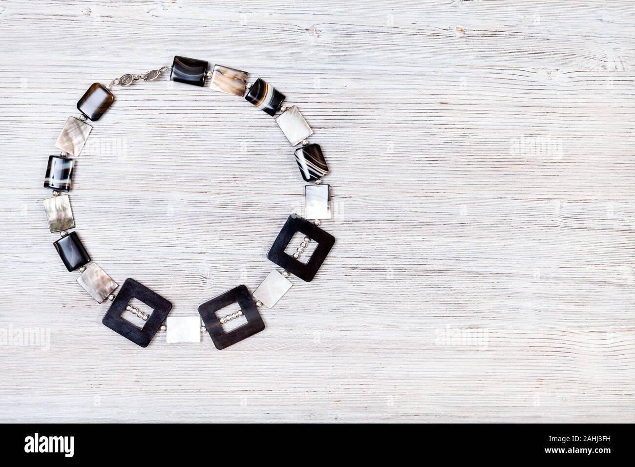 needlecraft background - top view of hand crafted necklace from horn ...