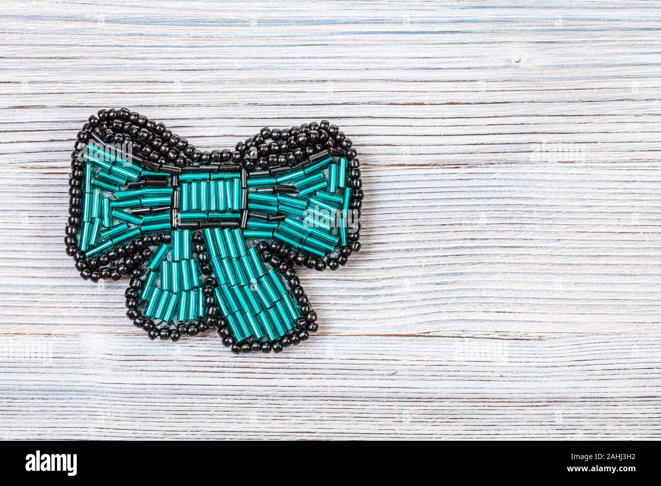 needlecraft background - top view of handcrafted bow tie brooch from ...
