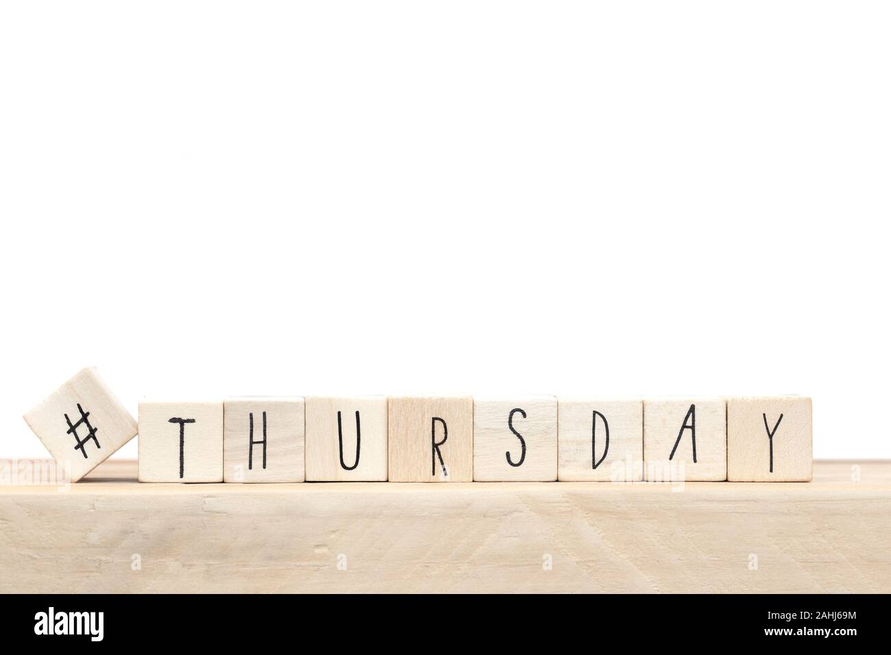 Wooden cubes with hashtag and the word Thursday, social media concept ...