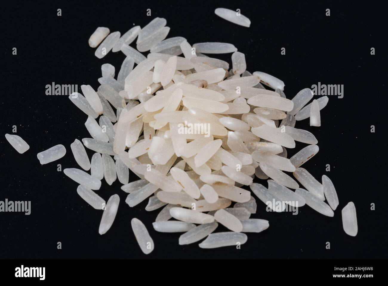 uncooked rice grains, a staple in any kitchen Stock Photo - Alamy
