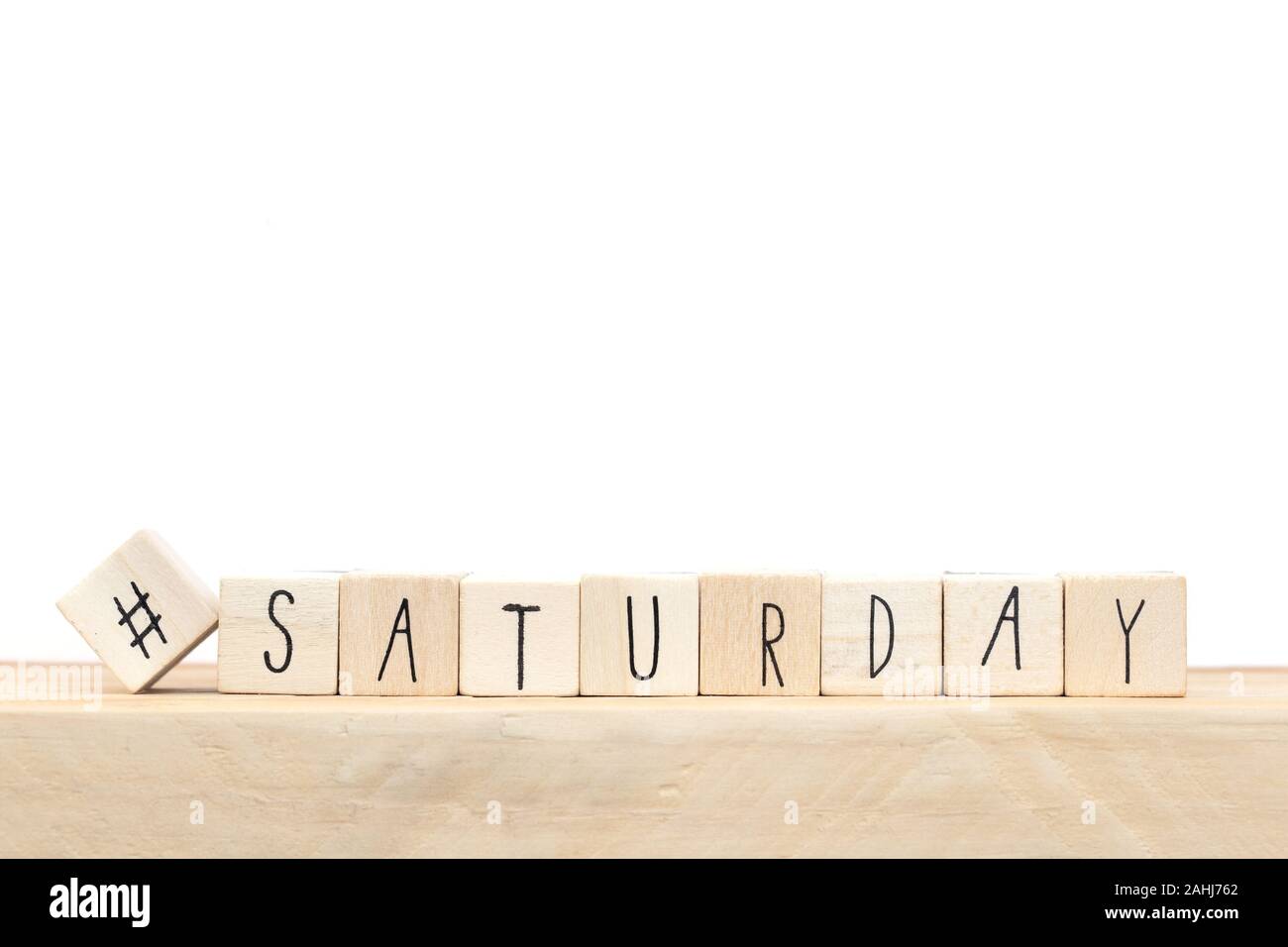 Wooden cubes with a hashtag and the word Saturday, social media concept ...