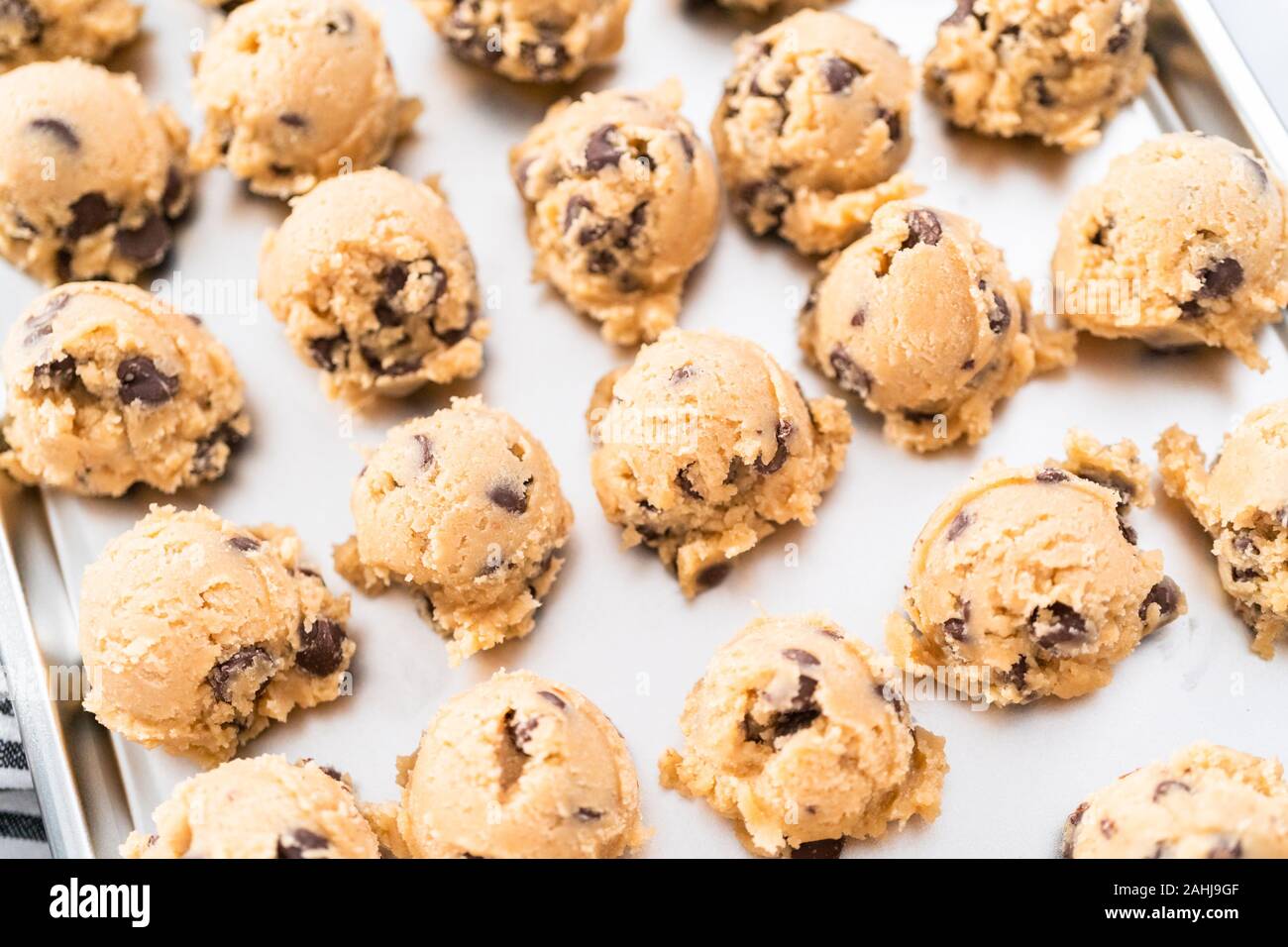 Homemade chocolate chip cookies dough scoops on a baking sheet Stock ...