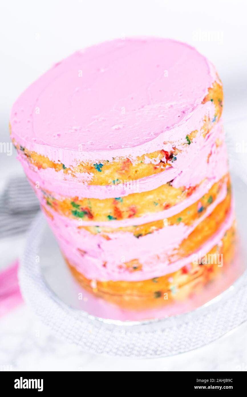 Funfetti cake layers with pink buttercream frosting Stock Photo - Alamy