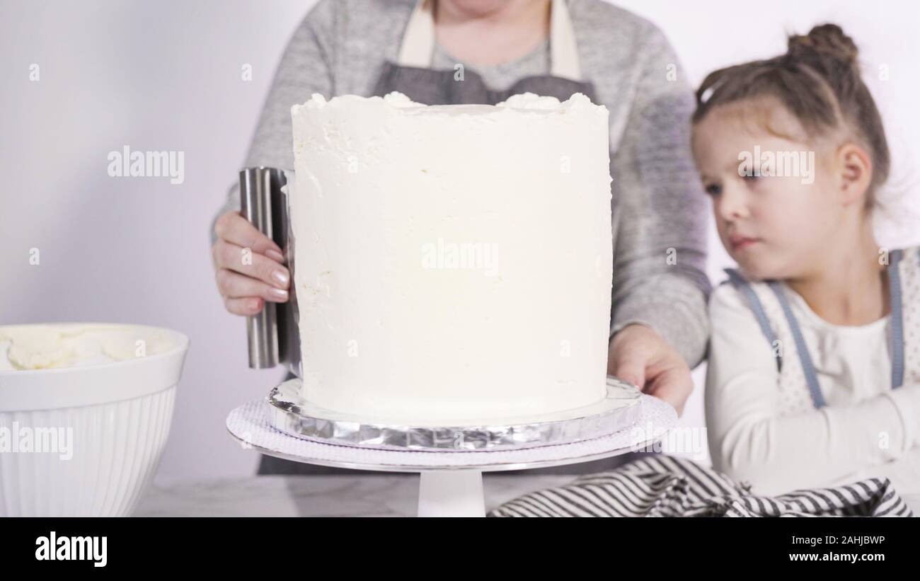 Step by step. Frosting round funfetti cake with white italian ...